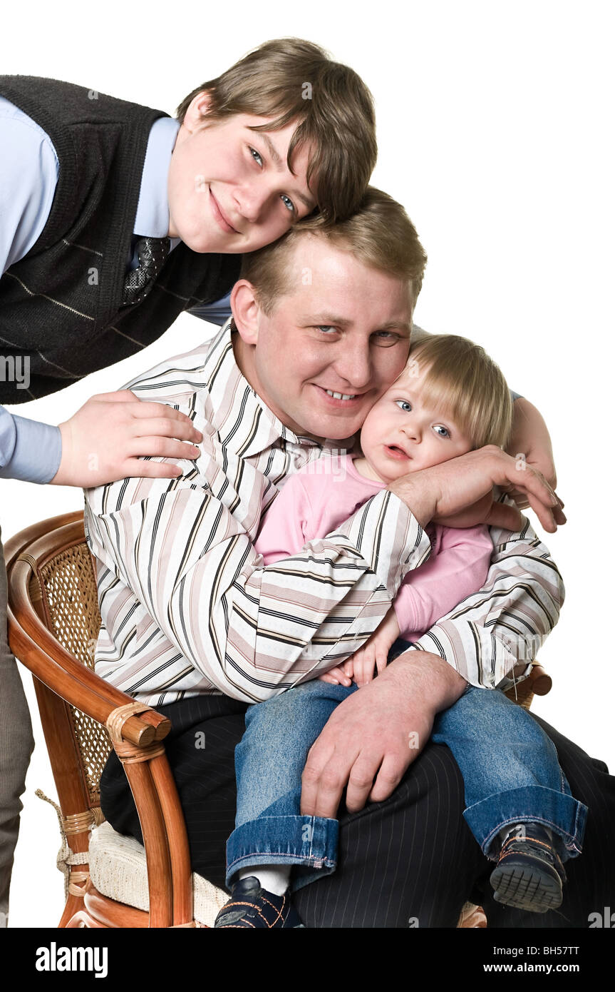 Father and his children are embracing. Affectionate three people family ...