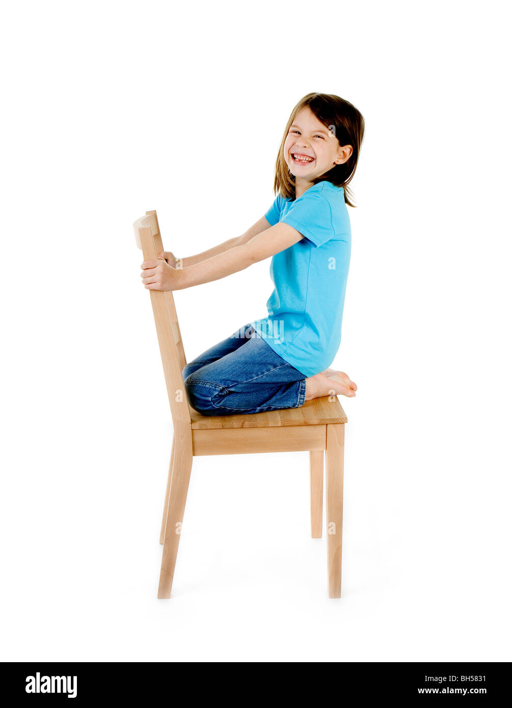girk having fun on wooden chair Stock Photo - Alamy