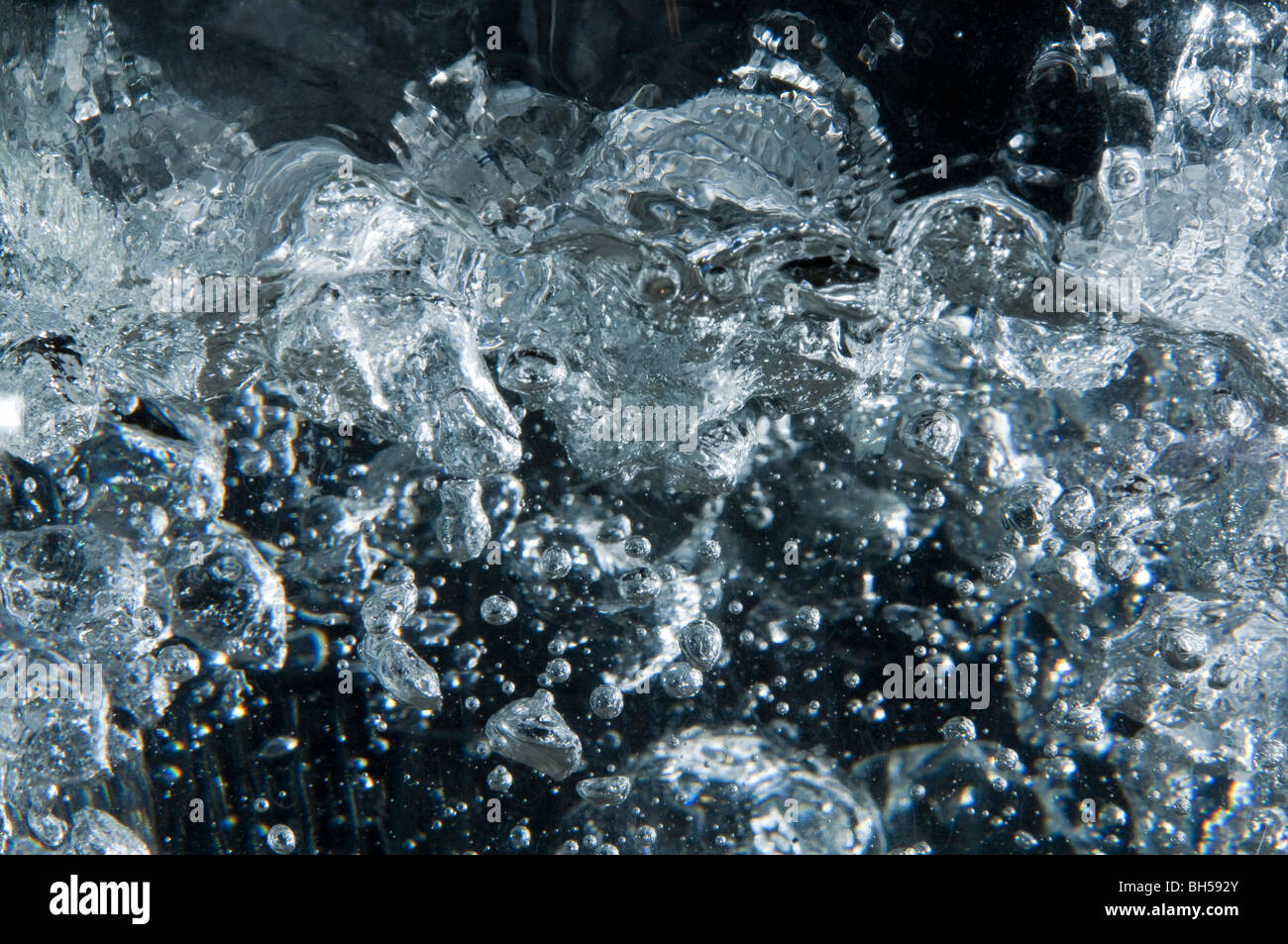 Water boiling in a glass container Stock Photo - Alamy