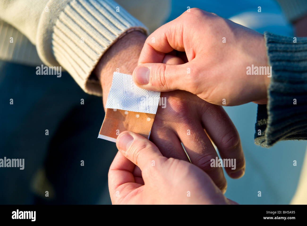 Applying a plaster to a hand Stock Photo - Alamy