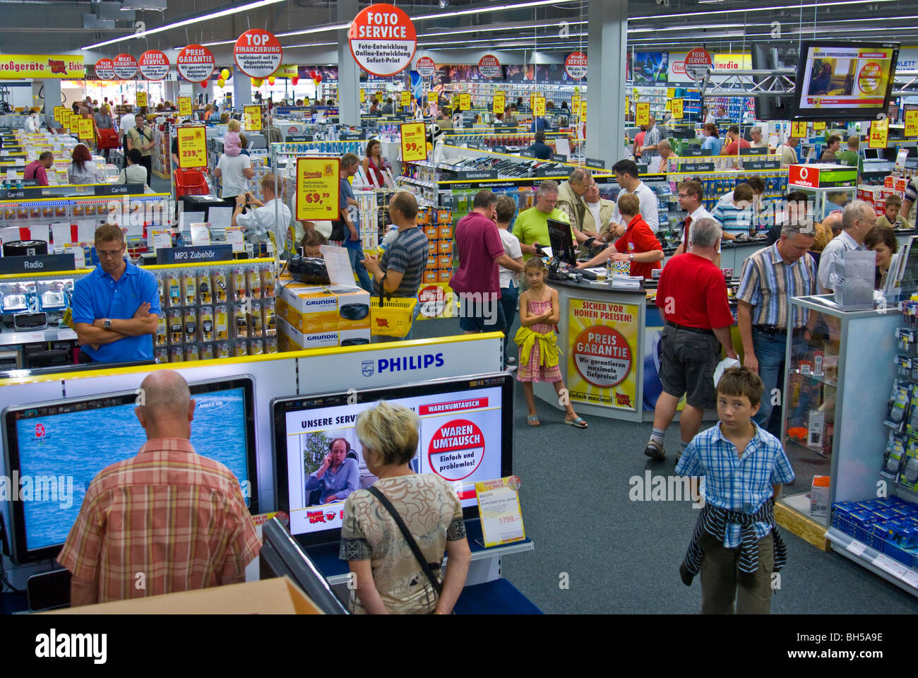 People shopping in electronic store at German shopping centre near ...