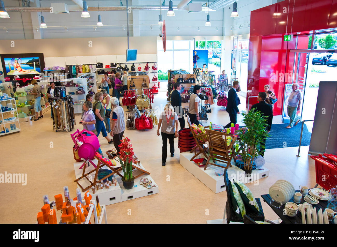 People entering and shopping inside a discount retail fashion shop ...