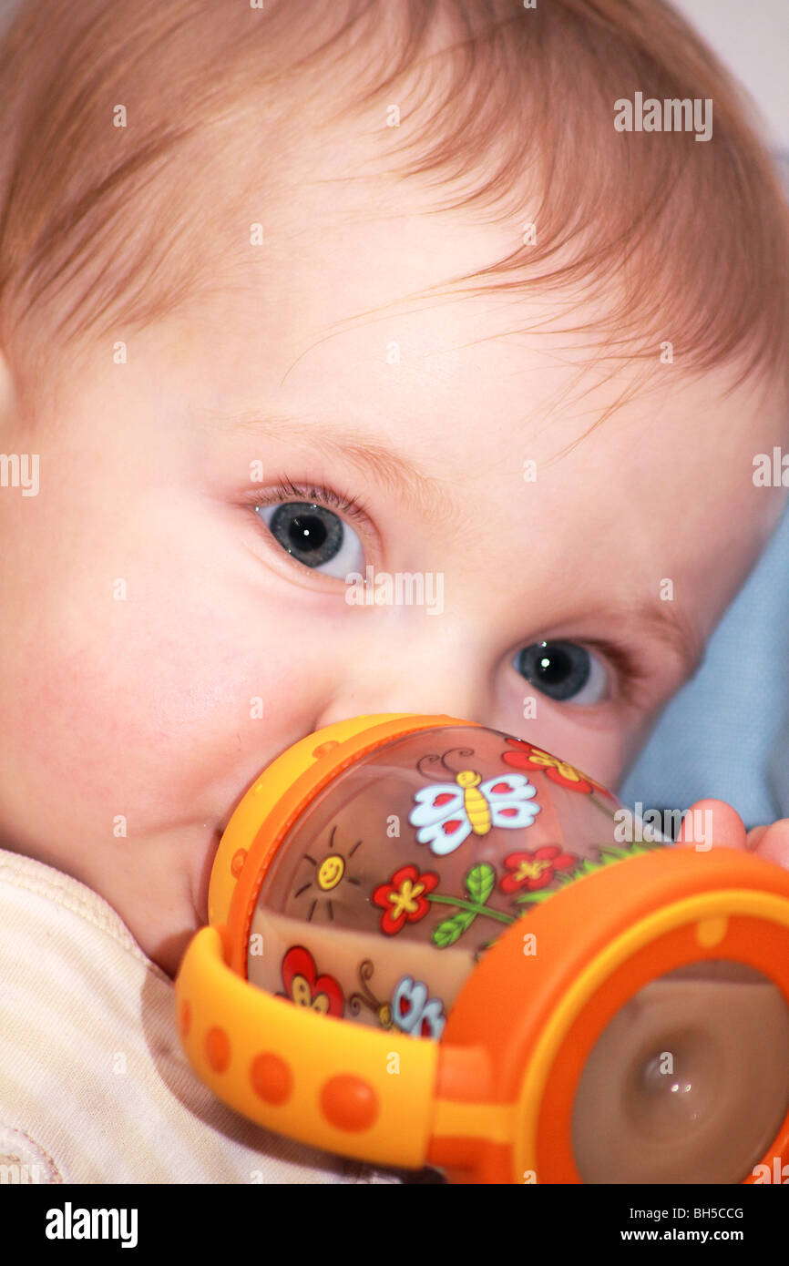 Portrait of beautiful baby drinks a juice Stock Photo - Alamy
