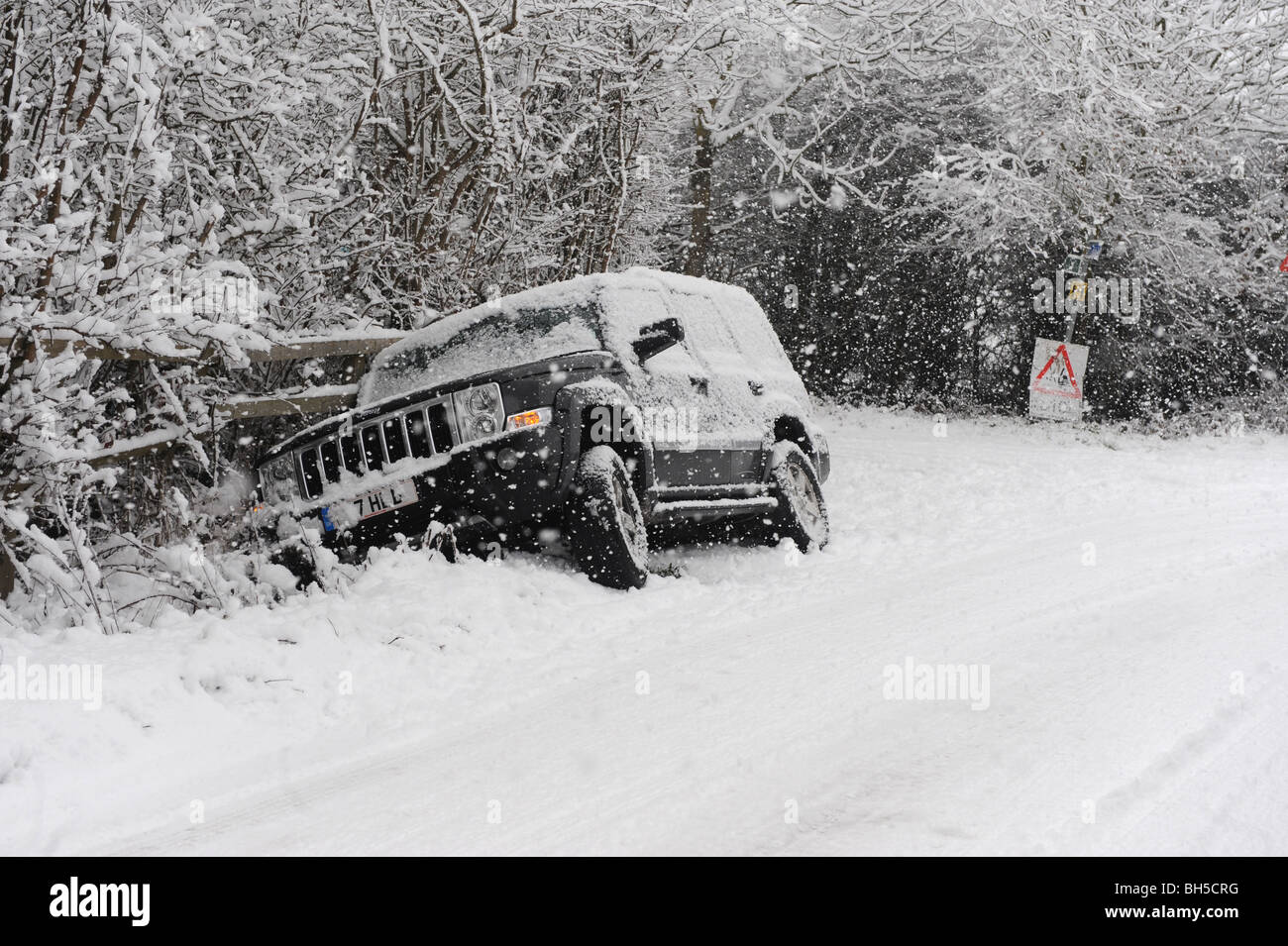 A car lays in a ditch after losing control control during icy driving ...