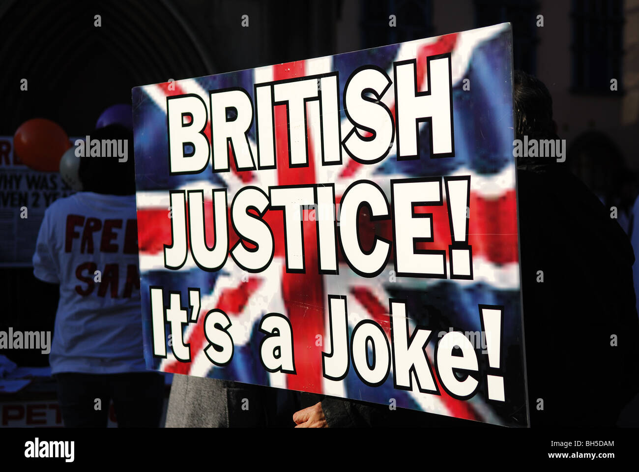 Protesters British Justice! It's a Joke Sign Stock Photo - Alamy