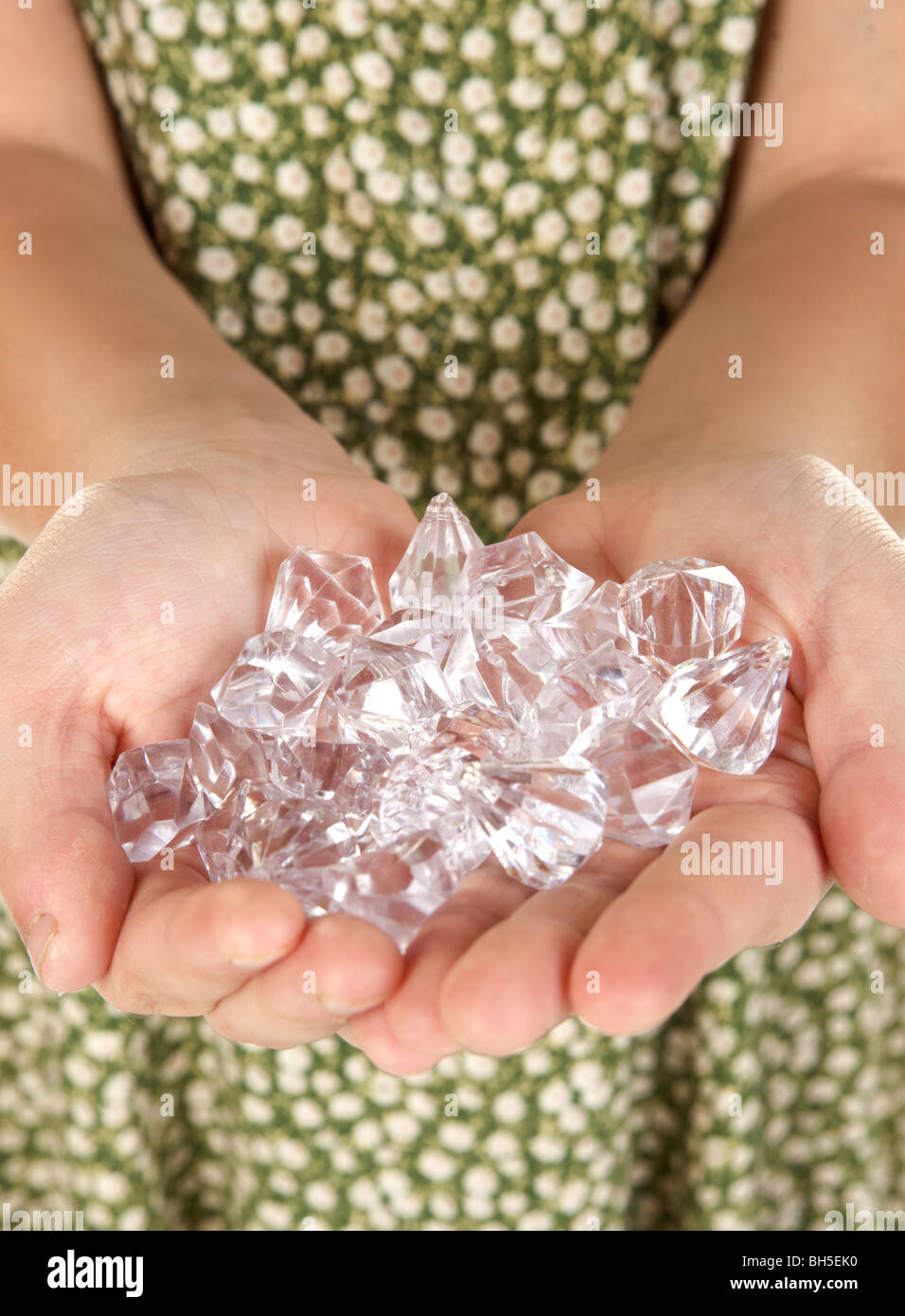 image of someone holding two handfuls of diamonds Stock Photo - Alamy