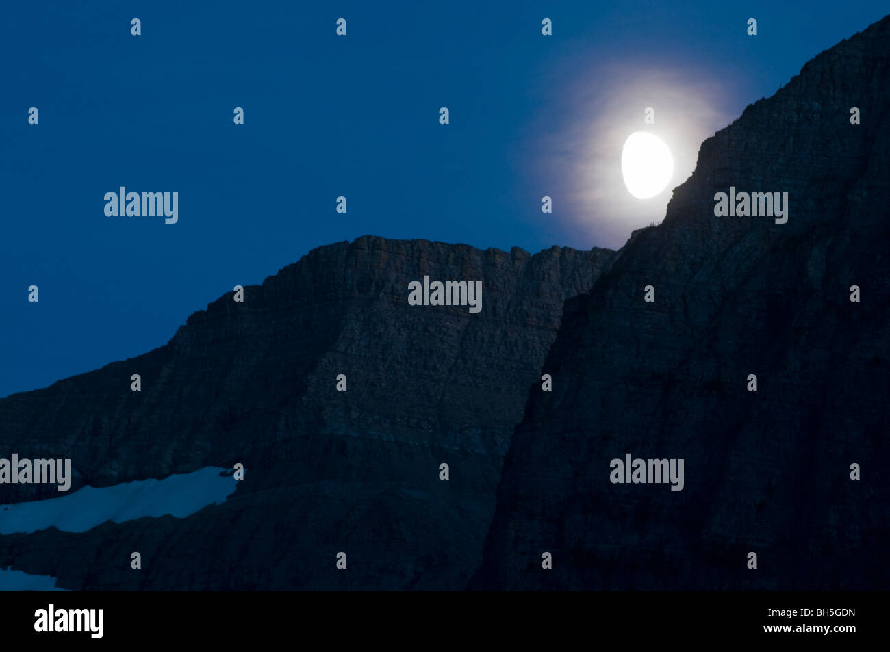hazy moon setting in dusk sky behind Red Eagle Mountain Stock Photo - Alamy