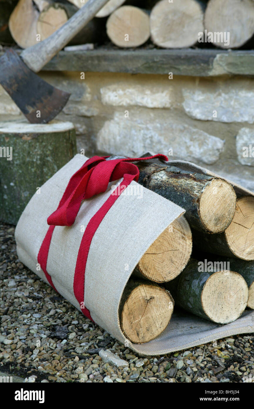 detail closeup of logs stored on stone shelf with carry bag and Axe in ...