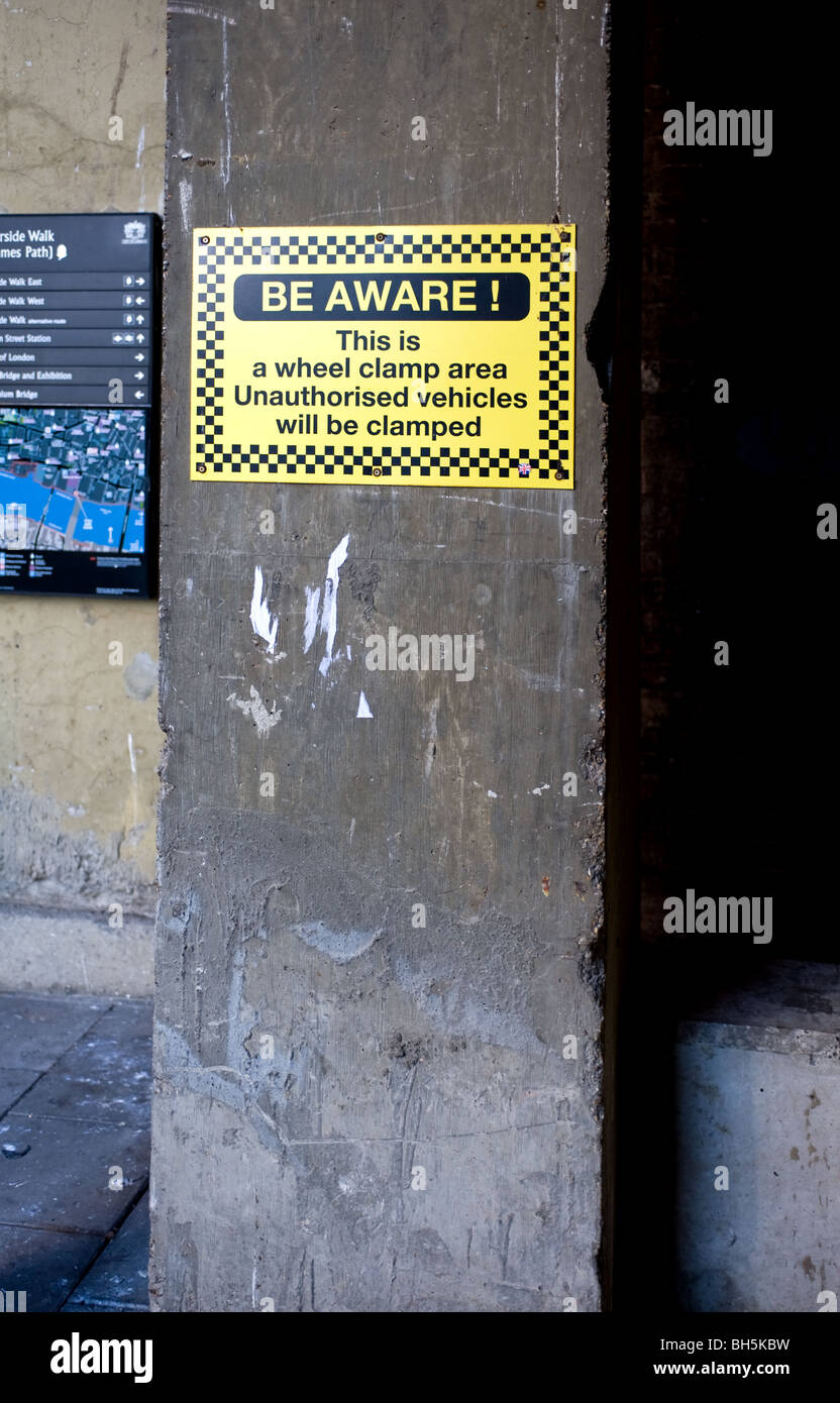 A wheel clamping warning sign on a wall in . Photo by Gordon Scammell ...