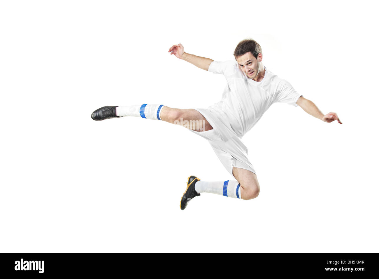 Soccer player jumping isolated on white background Stock Photo - Alamy
