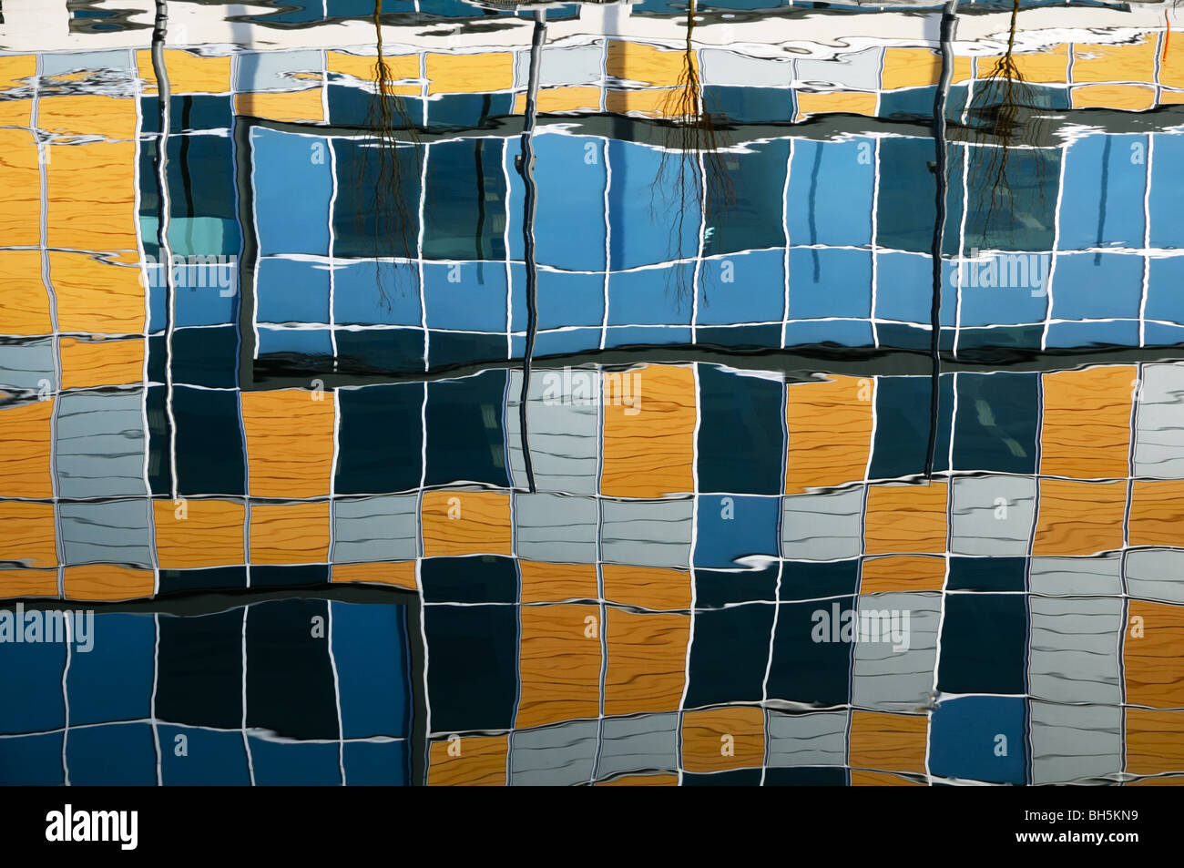 Reflection of a contemporary office building in a river with ...