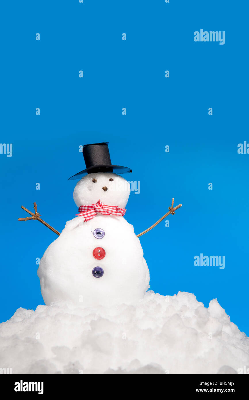 Miniature Snowman On Mound Of Snow With Blue Sky Behind Stock Photo - Alamy