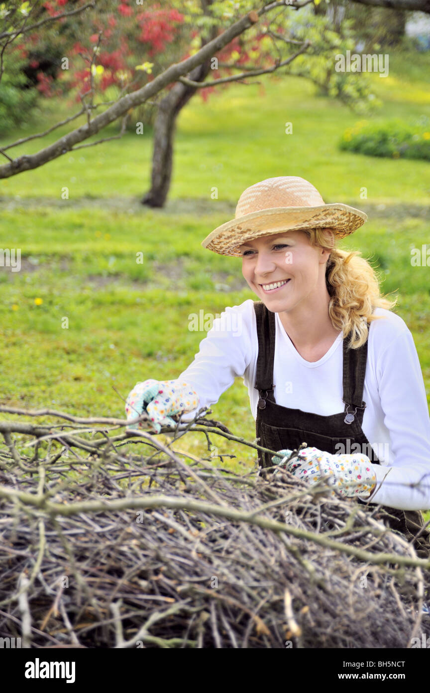 Young woman cleaning tree limbs in orchard Stock Photo - Alamy