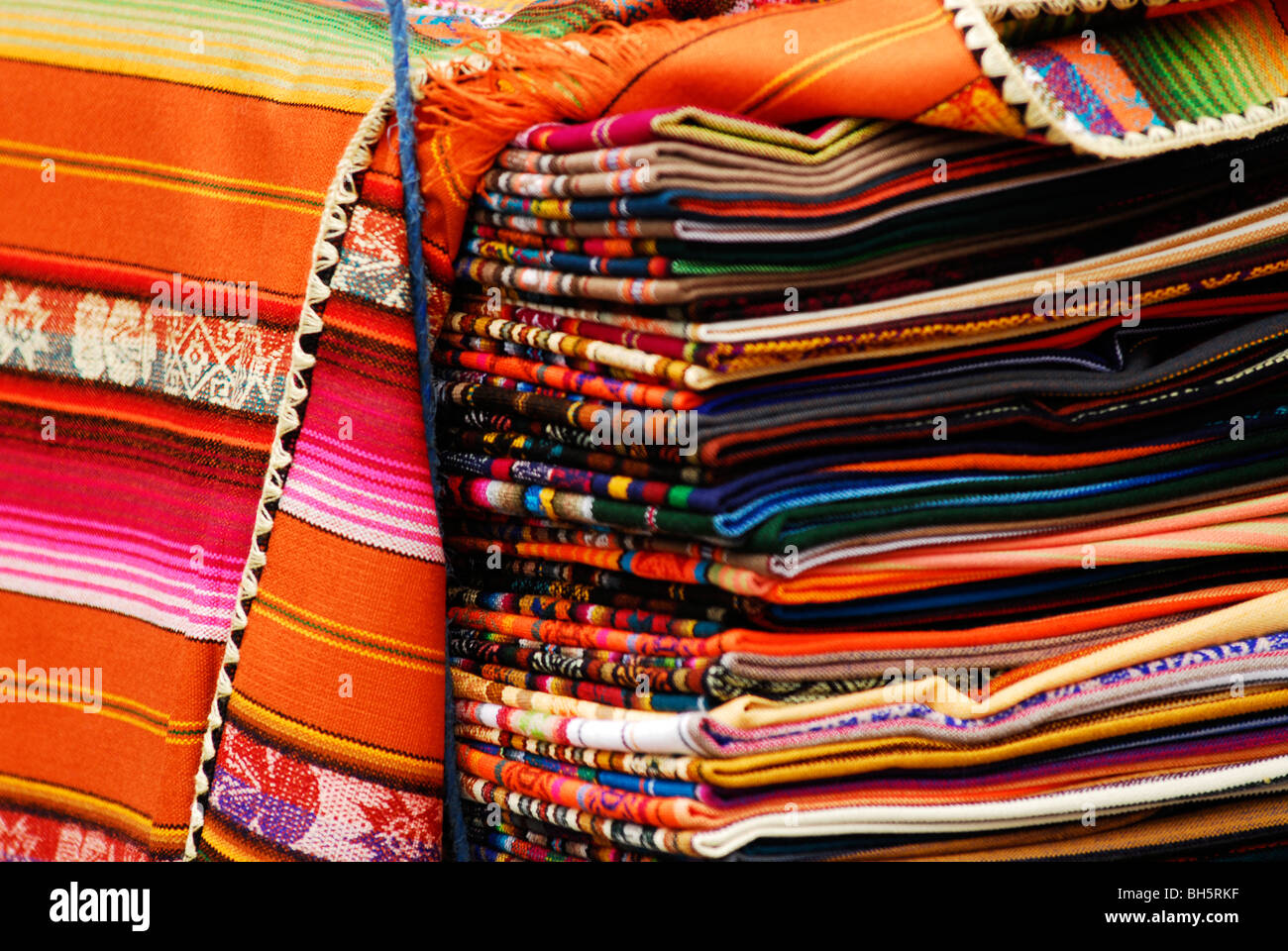 Ecuador, Otavalo, view of a stack of colorful textile materials at a ...