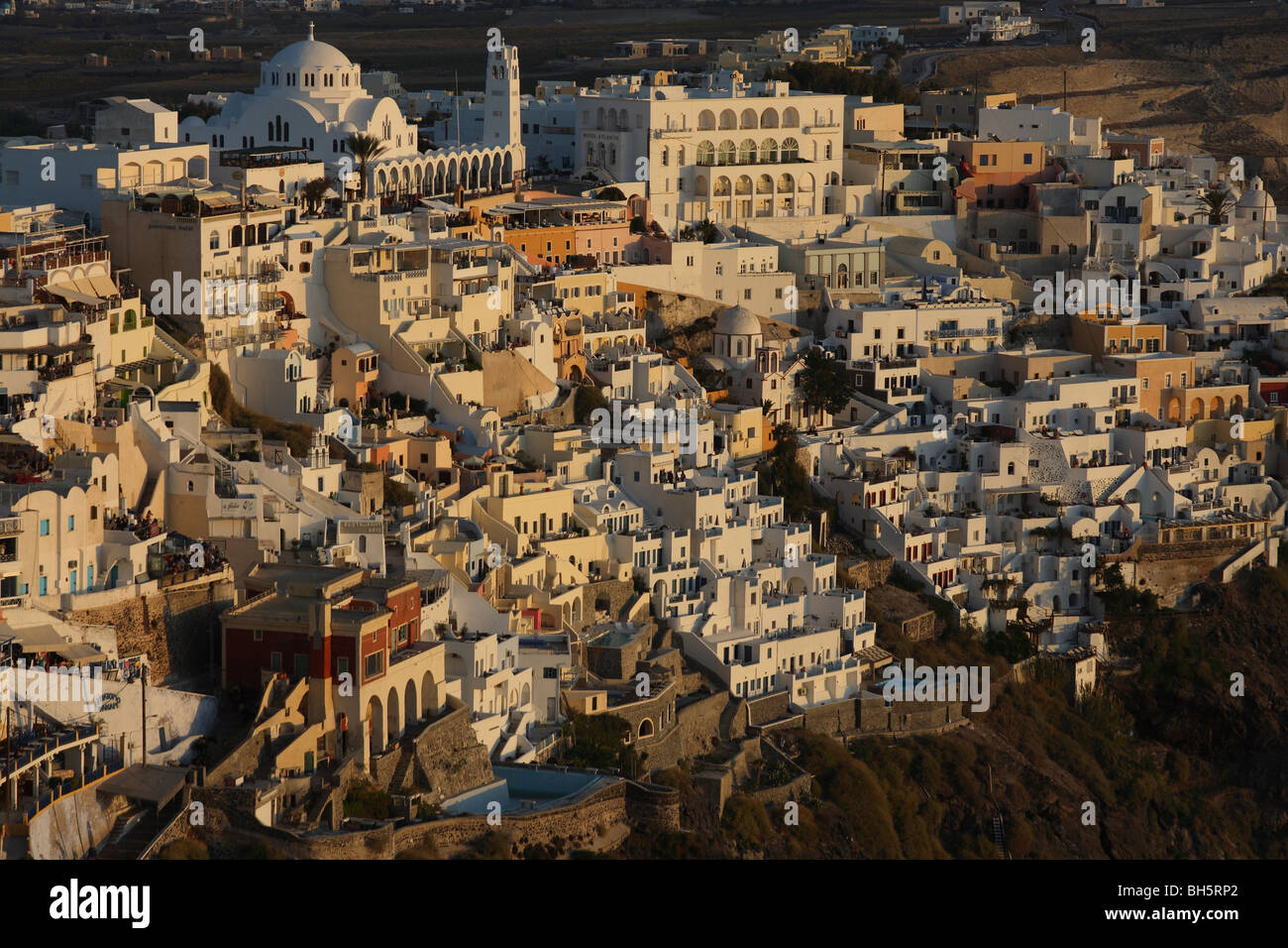 sunset time with golden light caldera and town of fira in santorini ...