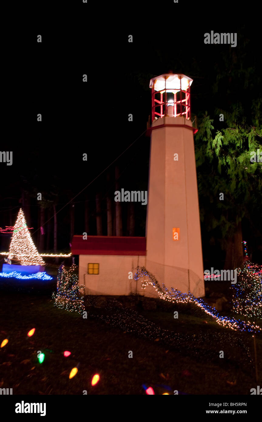 This Christmas lighthouse is stunning at night with trees in the ...