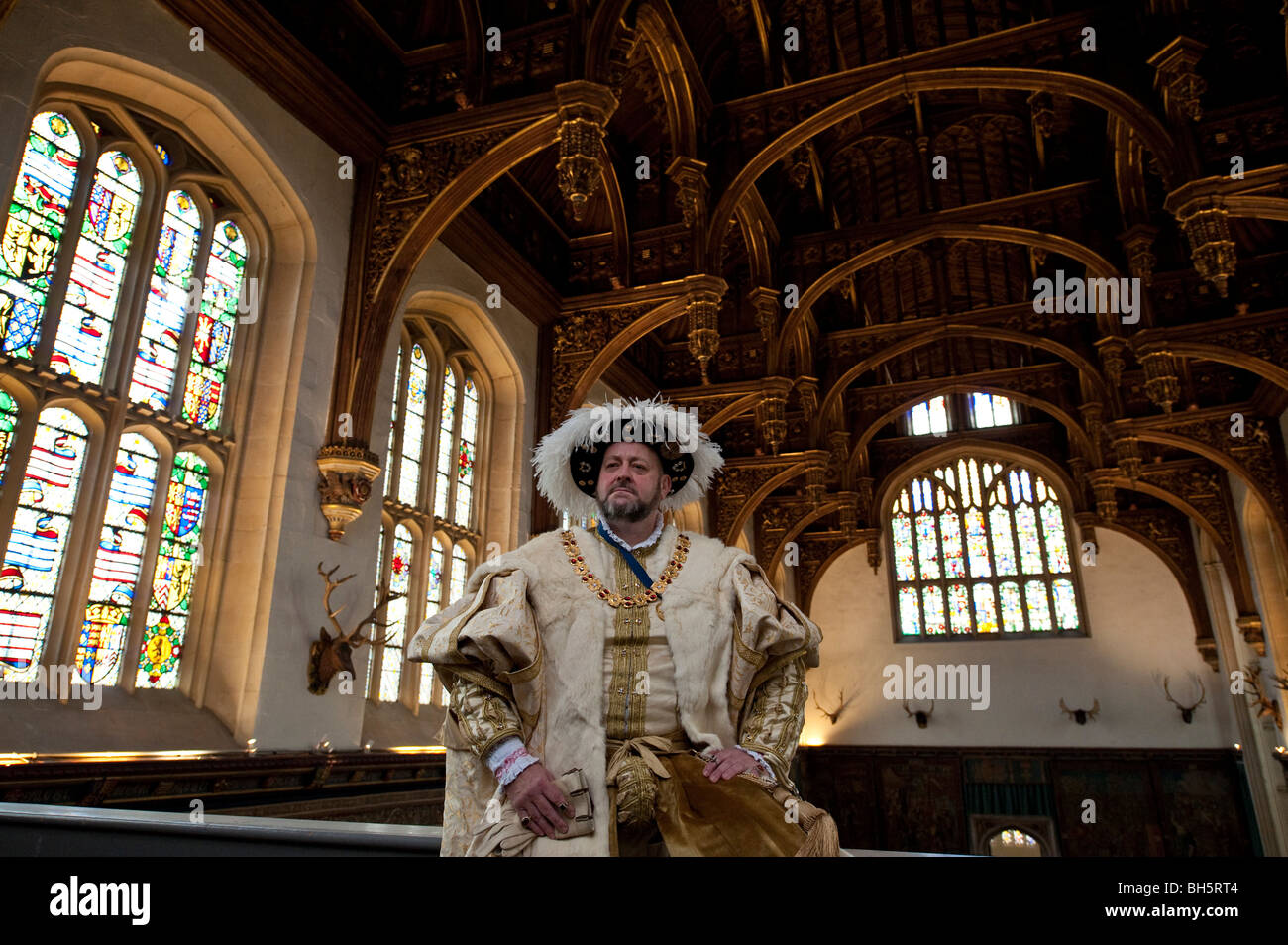 Actor wearing Henry VIII costume posing in the Great Hall at Hampton ...
