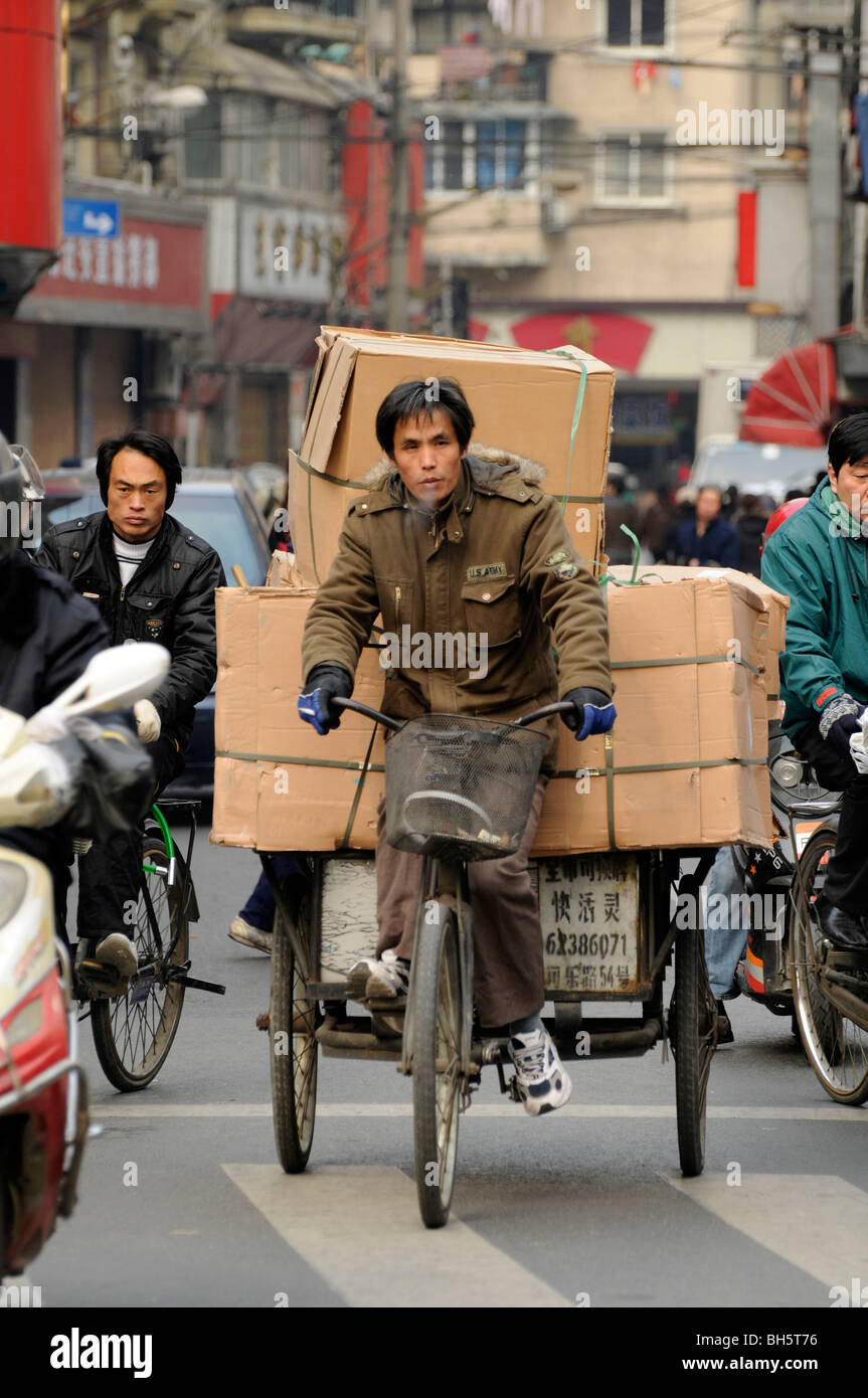 Chinese man delivering boxes by bicycle, Shanghai, China Stock Photo ...