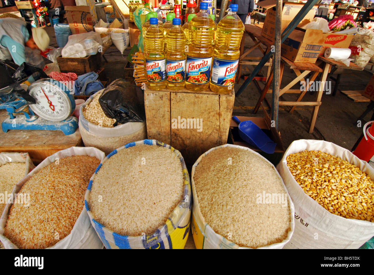 Ecuador, Saquisili, sacks of grain and cooking oil on display in a ...
