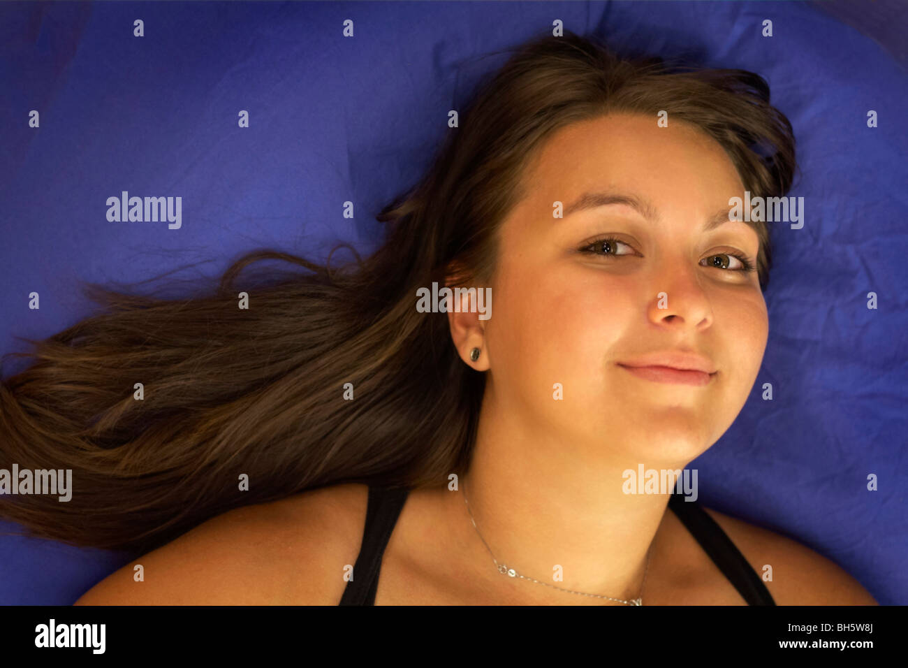A young girl alone smiling and happy Stock Photo - Alamy