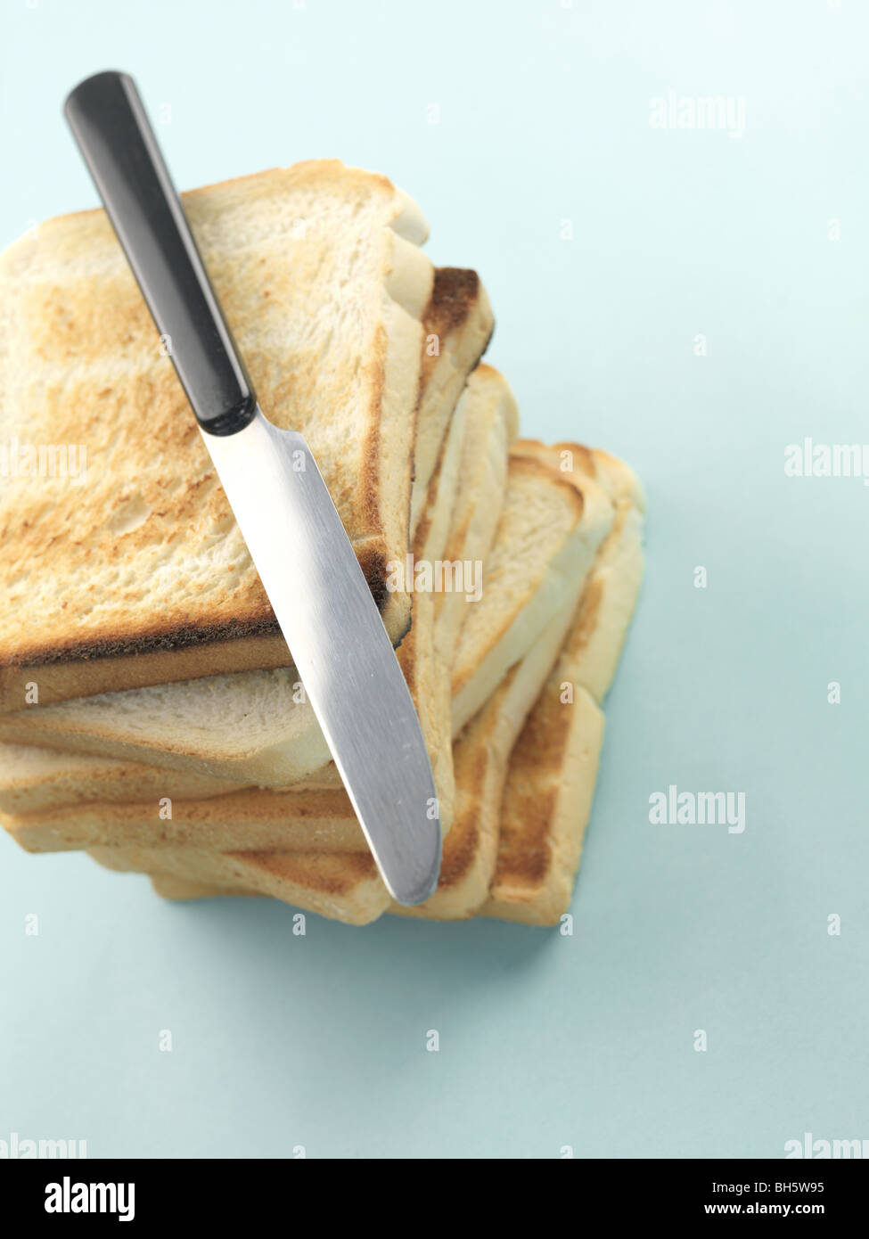 Plain white toast isolated against a pale blue background Stock Photo ...