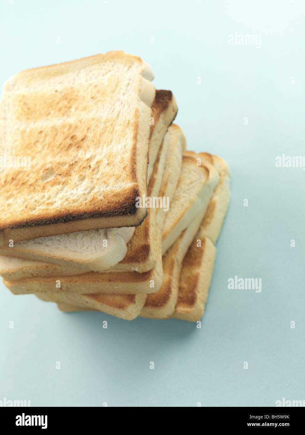 Plain white toast isolated against a pale blue background Stock Photo ...