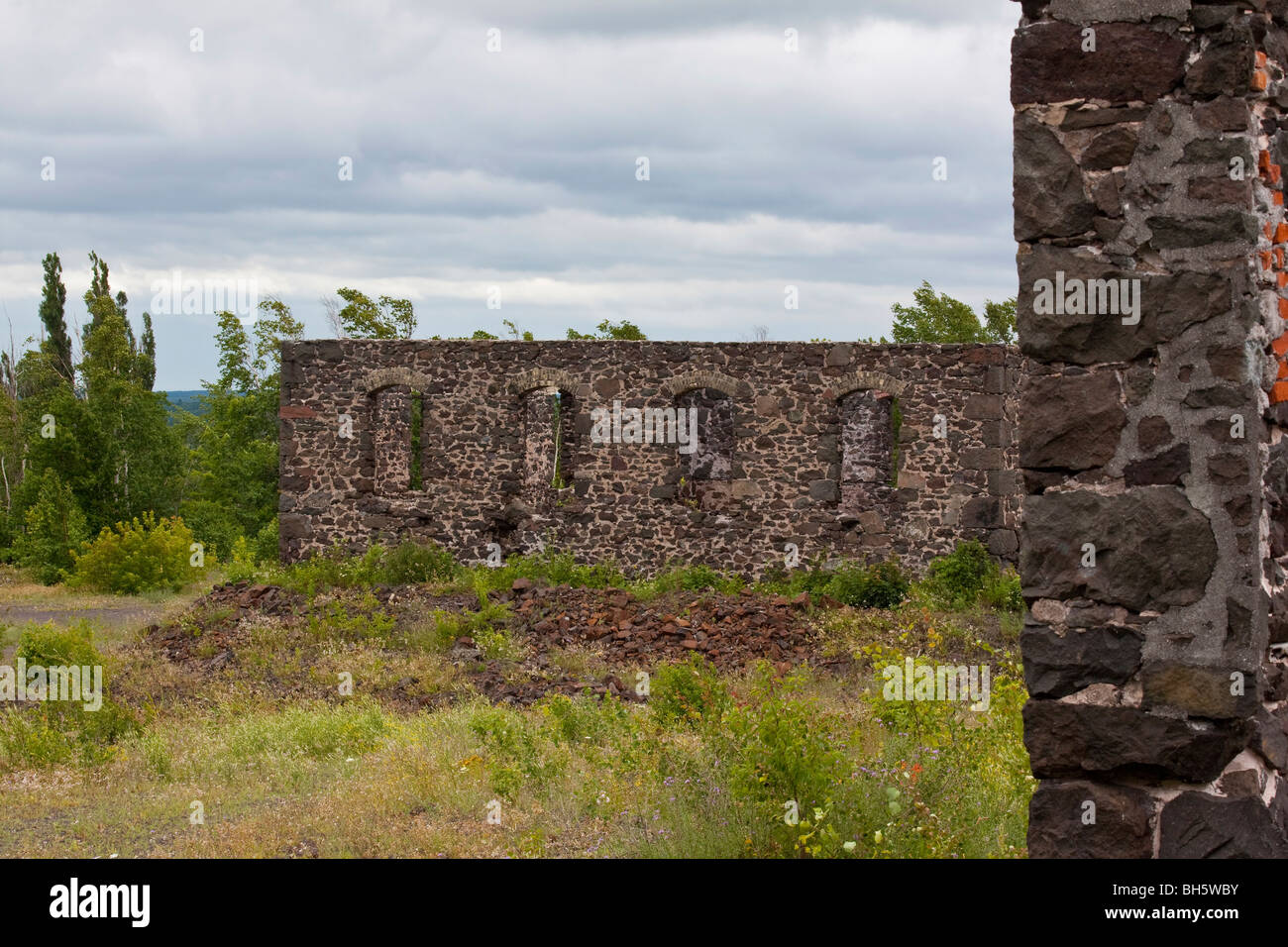 Abandoned ruined building with windows in a stone wall block in ...