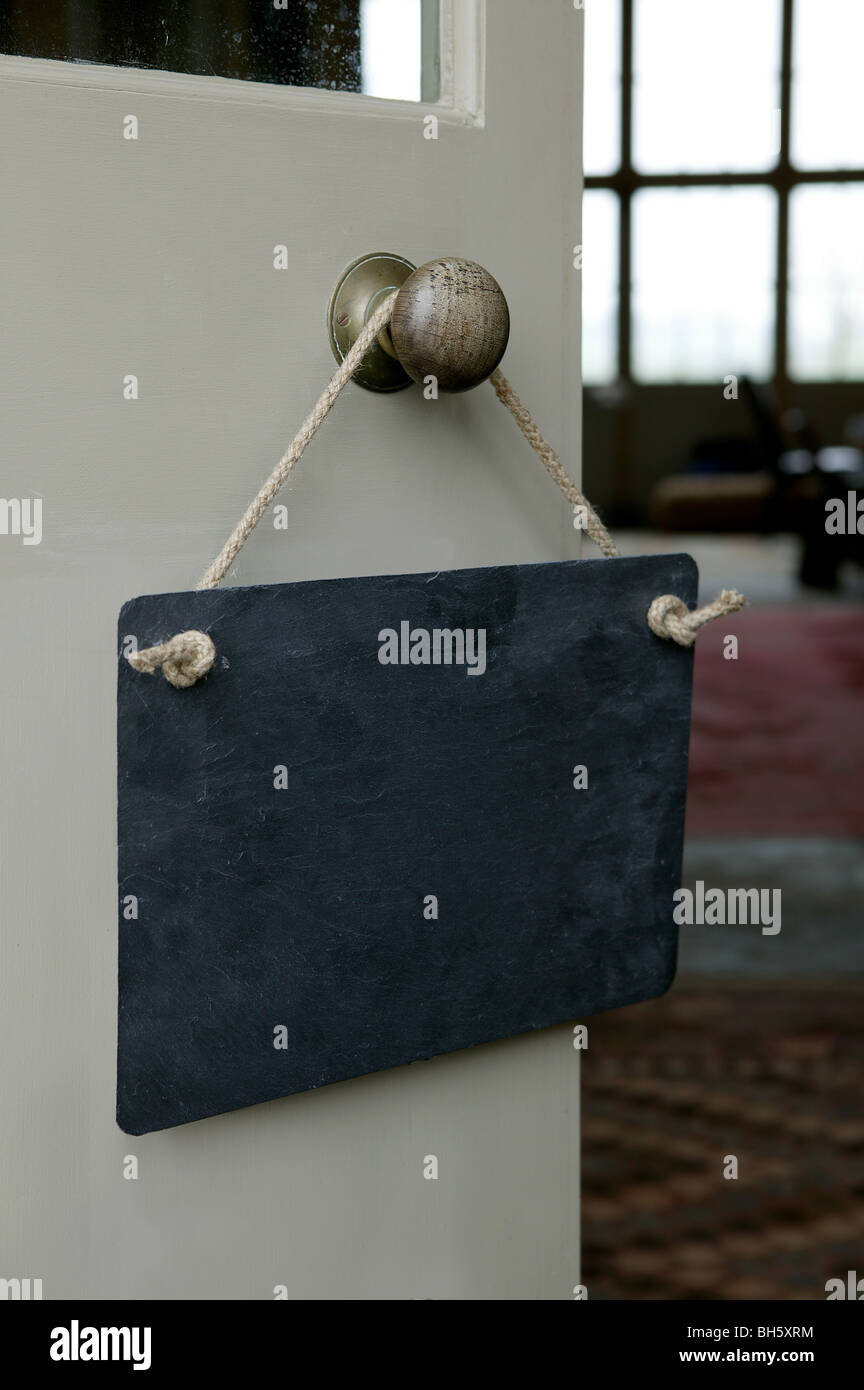 blank sign hanging from door handle. A welcome note needs inserting ...