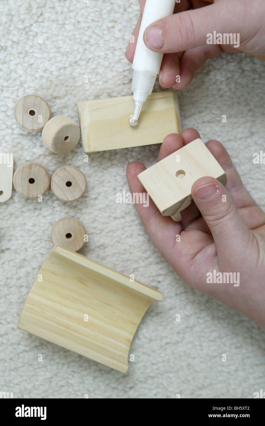 Childrens hand constructing wooden toys Stock Photo - Alamy