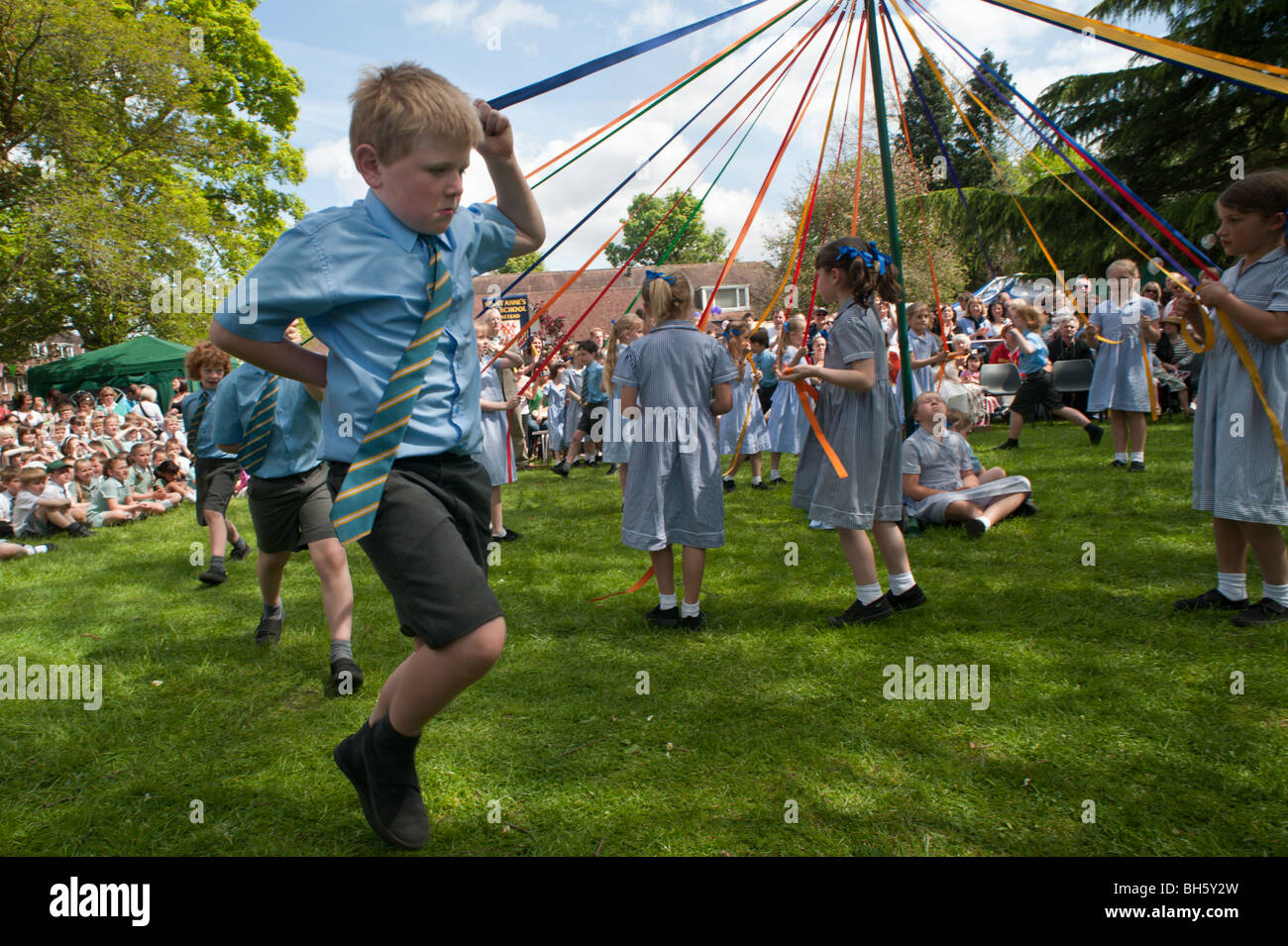 Banstead Village May Fayre. A schoolboy in uniform and young ...