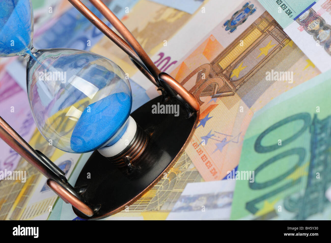 Time money sand glass european currency hi-res stock photography and ...