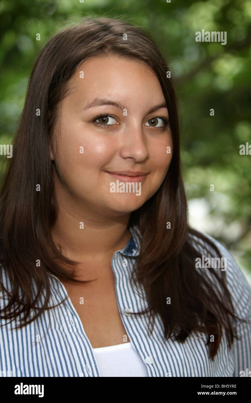 A young girl alone smiling and happy Stock Photo - Alamy