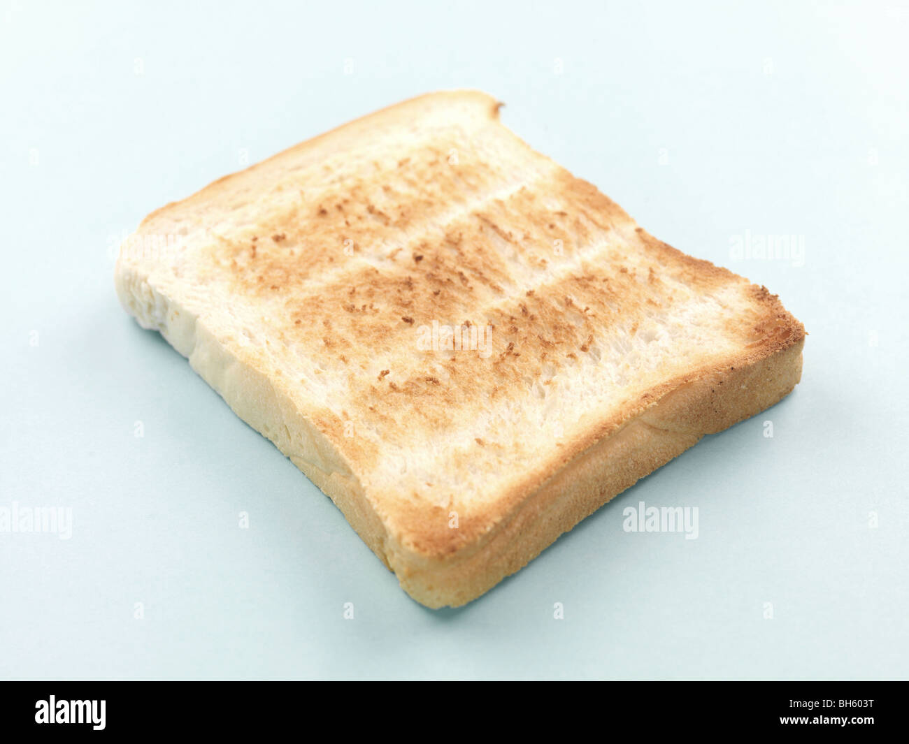 Plain white toast isolated against a pale blue background Stock Photo ...