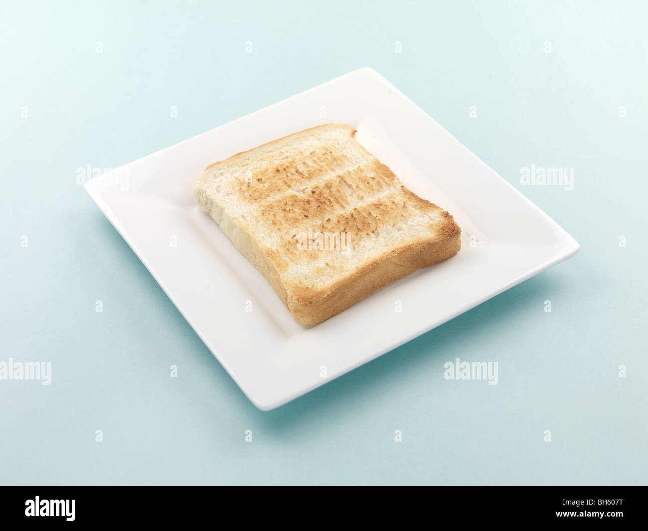 Plain white toast isolated against a pale blue background Stock Photo ...