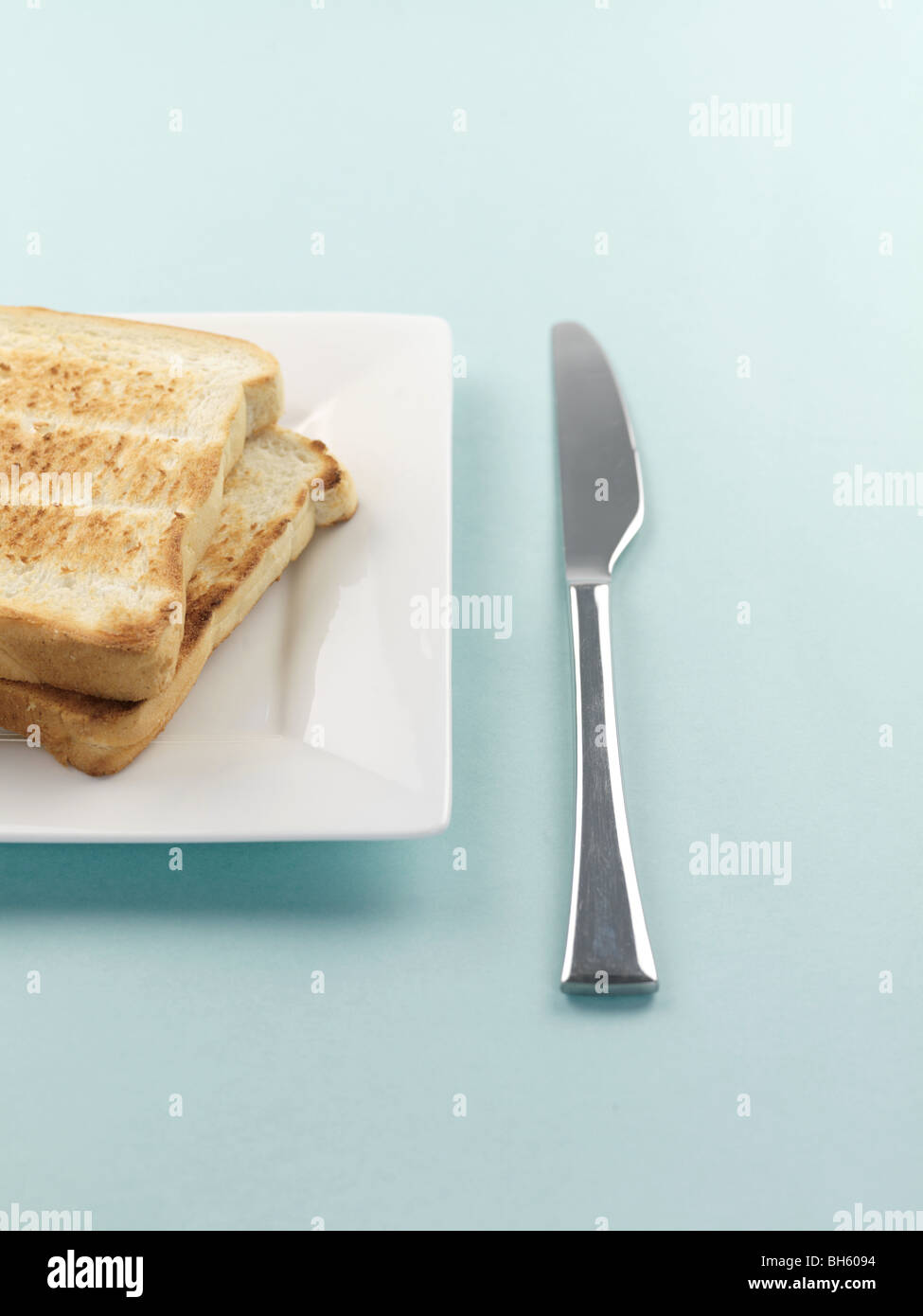 Plain white toast isolated against a pale blue background Stock Photo ...