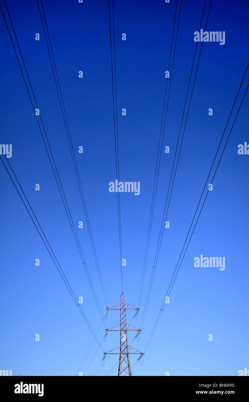 UK National Grid Electricity pylon, high power voltage cables and blue ...