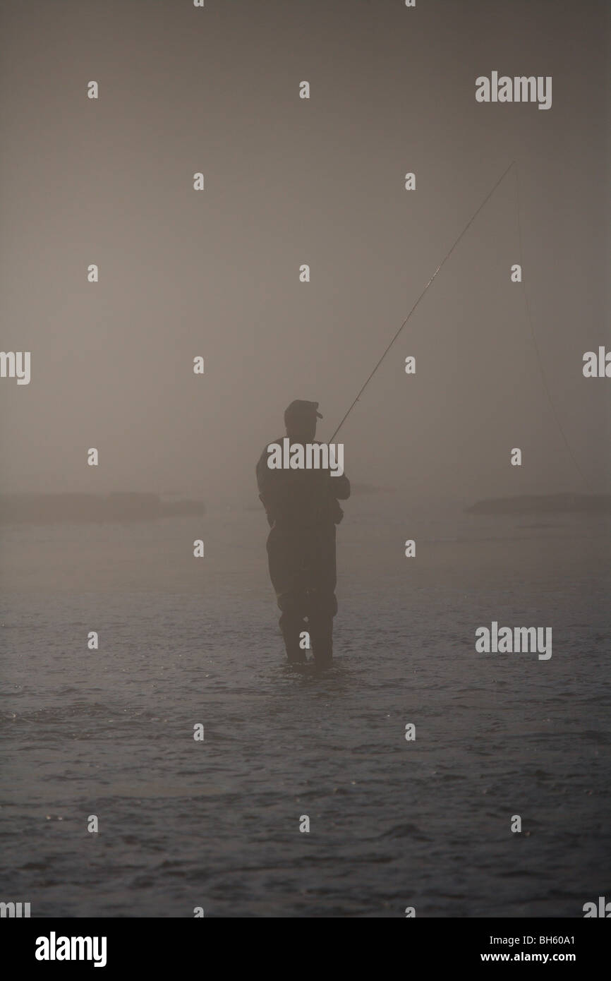 SILHOUETTE FLY FISHERMAN FISHING IN RIVER HEAVY FOG BAD WEATHER Stock ...