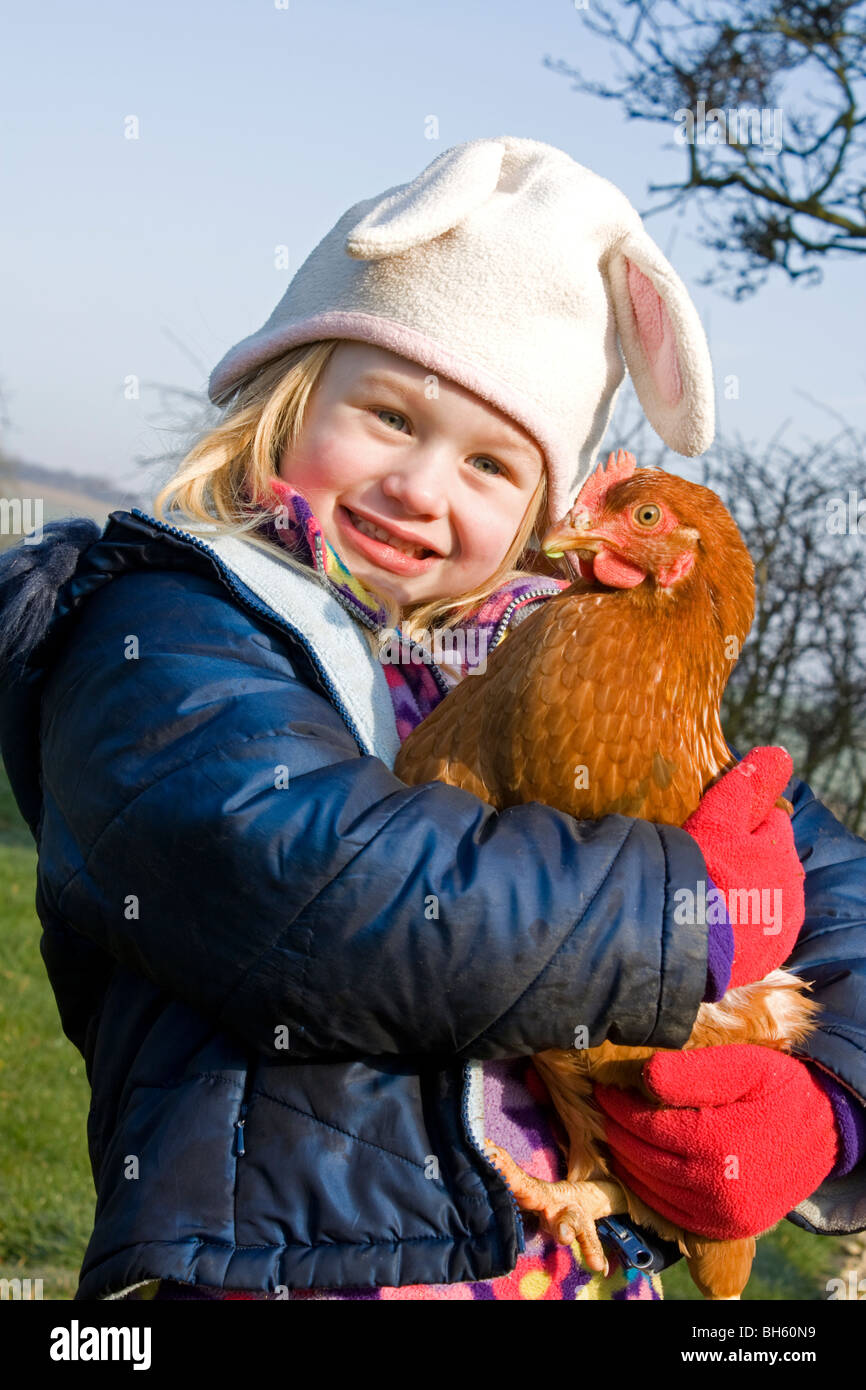 Young girl holding hen Stock Photo - Alamy