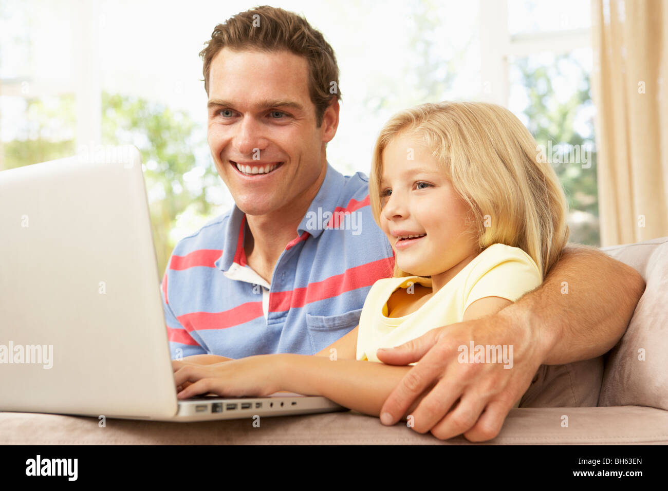 Father And Daughter Using Laptop At Home Stock Photo - Alamy
