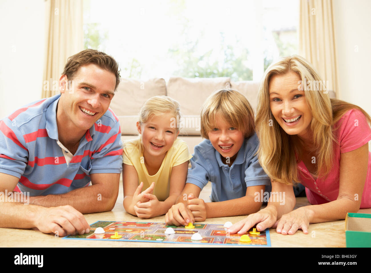 Family Playing Board Game At Home Stock Photo - Alamy