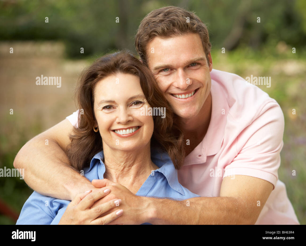 Senior Woman Being Hugged By Adult Son Stock Photo - Alamy