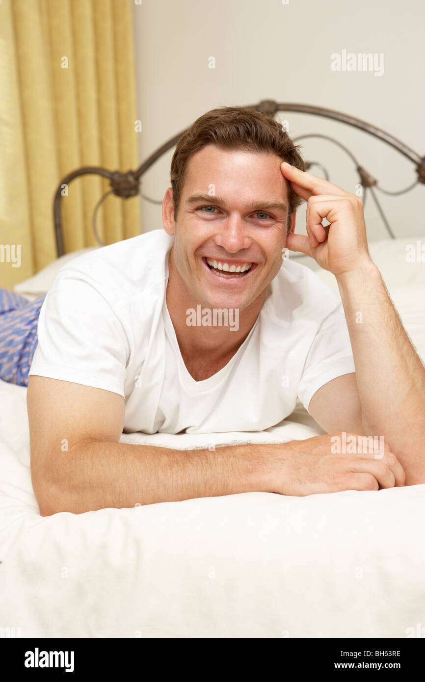 Man Relaxing On Bed At Home Stock Photo - Alamy