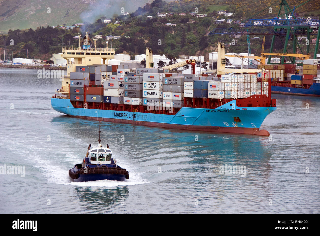 A tug with container ship in the background, Lyttelton, New Zealand ...