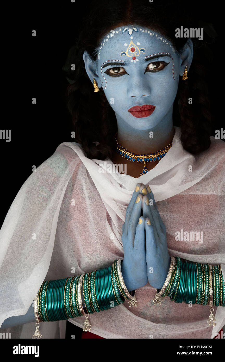 Indian girl face painted as the Hindu goddess Sita against a black ...