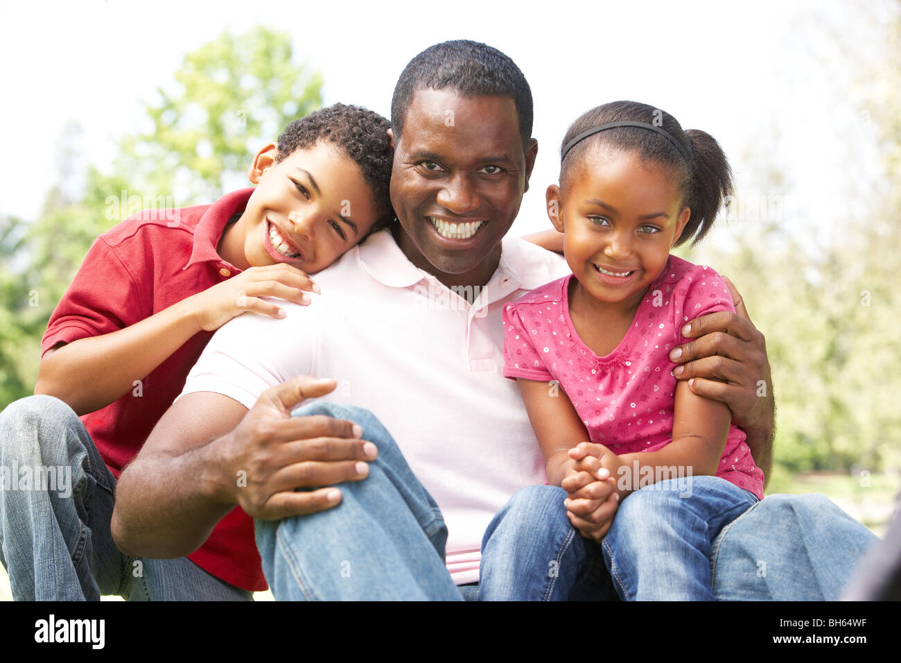 Father With Children In Park Stock Photo - Alamy