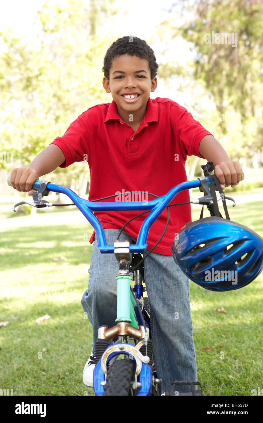 Boy Riding Bike In Park Stock Photo - Alamy