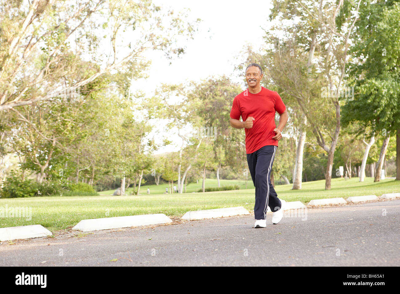 Senior Man Jogging In Park Stock Photo - Alamy