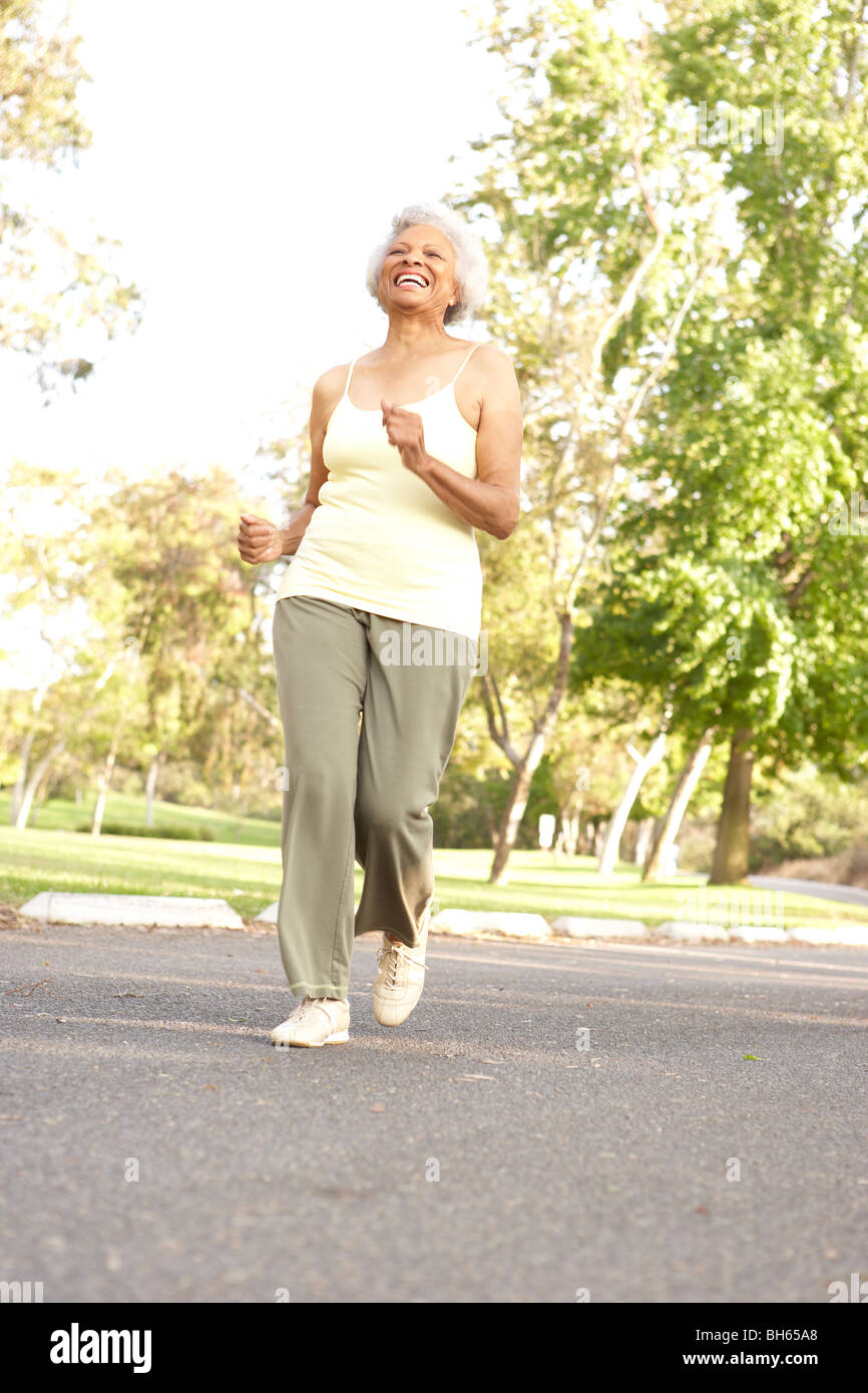 Senior Woman Jogging In Park Stock Photo - Alamy