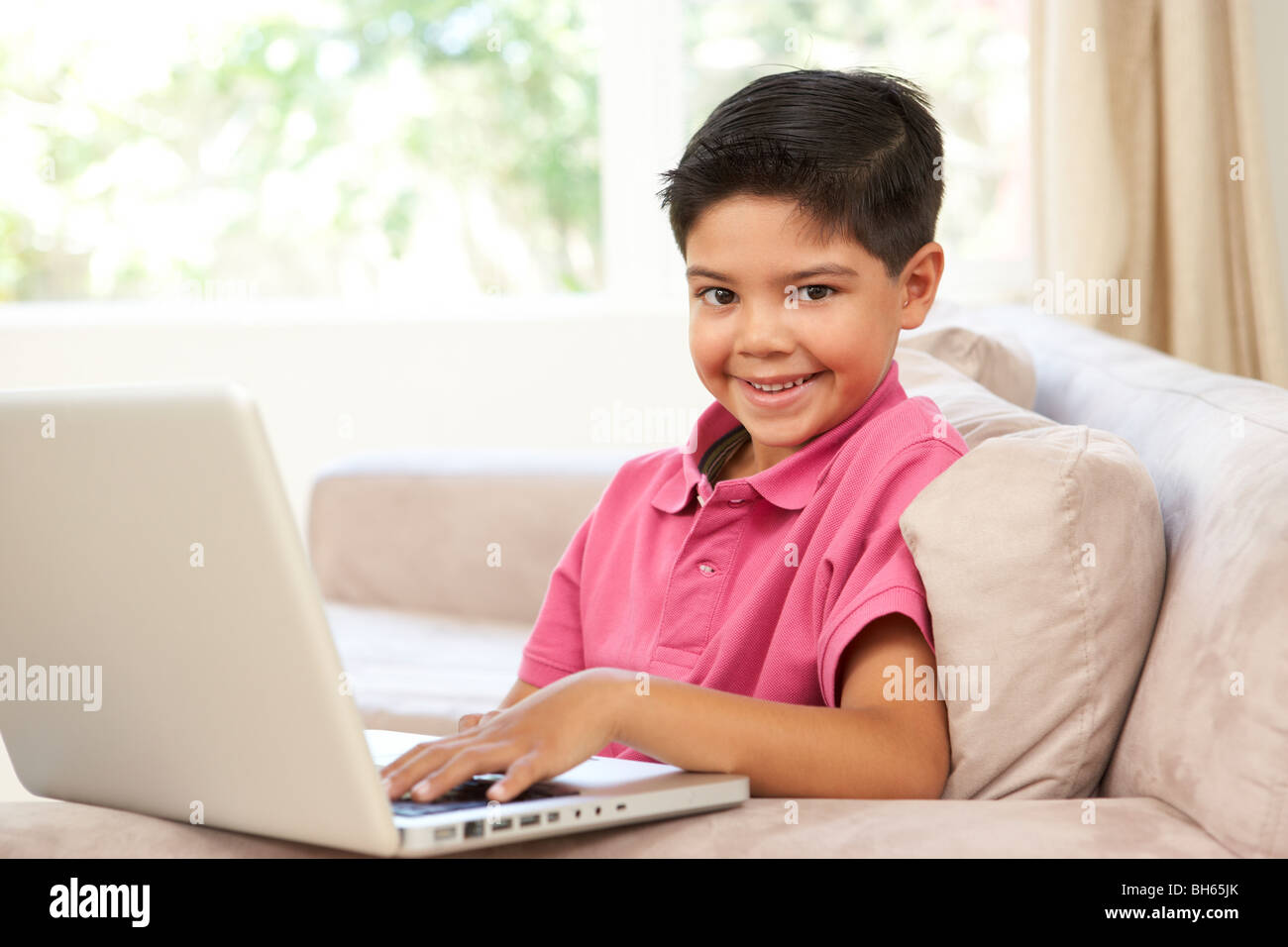 Young Boy Using Laptop At Home Stock Photo - Alamy
