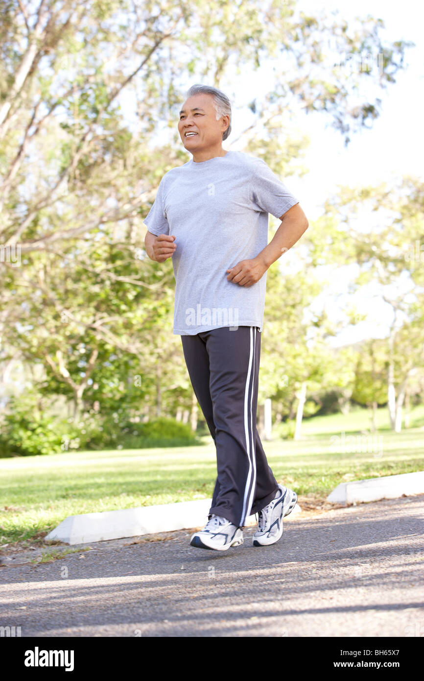 Senior Man Jogging In Park Stock Photo - Alamy